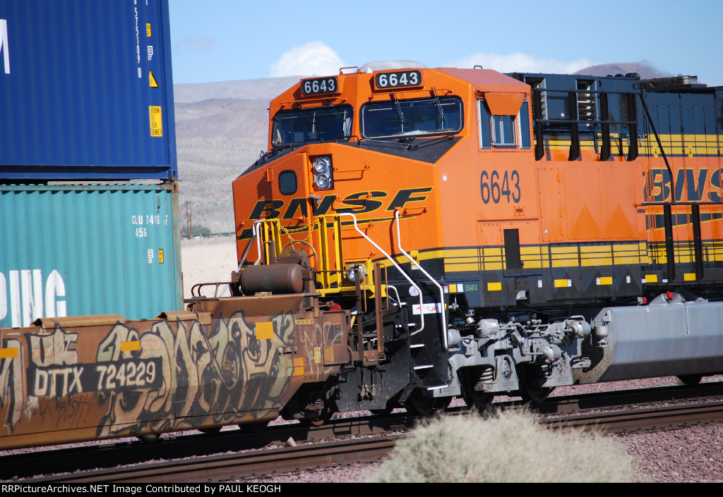Zoom in shot of BNSF 6643 as she pushes a westbound Z as a rear lead DPU.